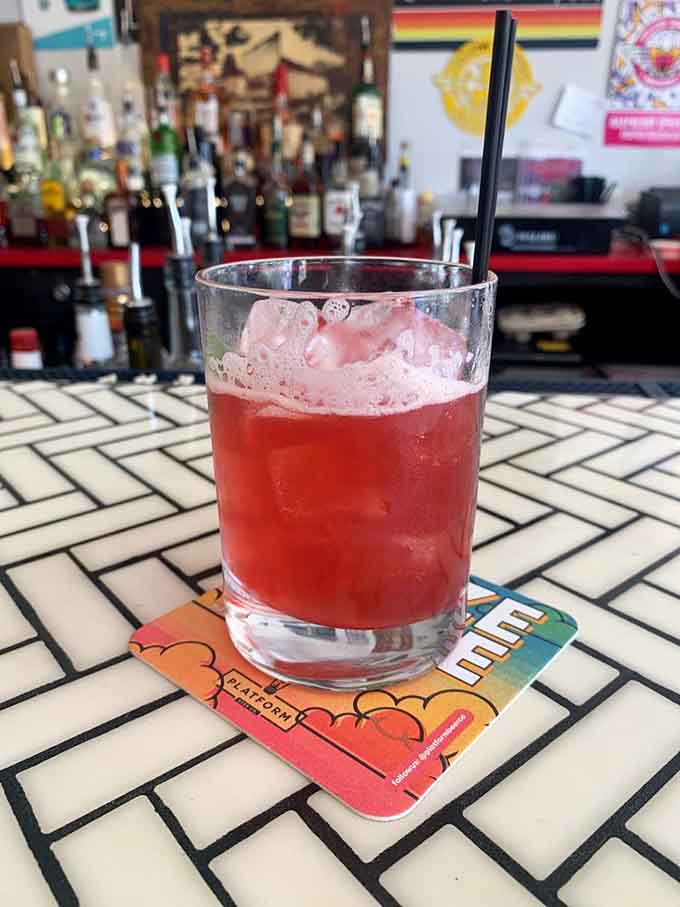 The Blackberry Basil Smash sits at the bar looking like the most refreshing decision you'll make all evening.