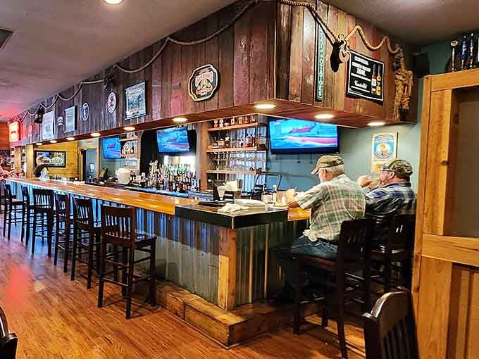 A full bar with wood accents and TVs overhead. Comfortable, casual, and exactly where you want to be.
