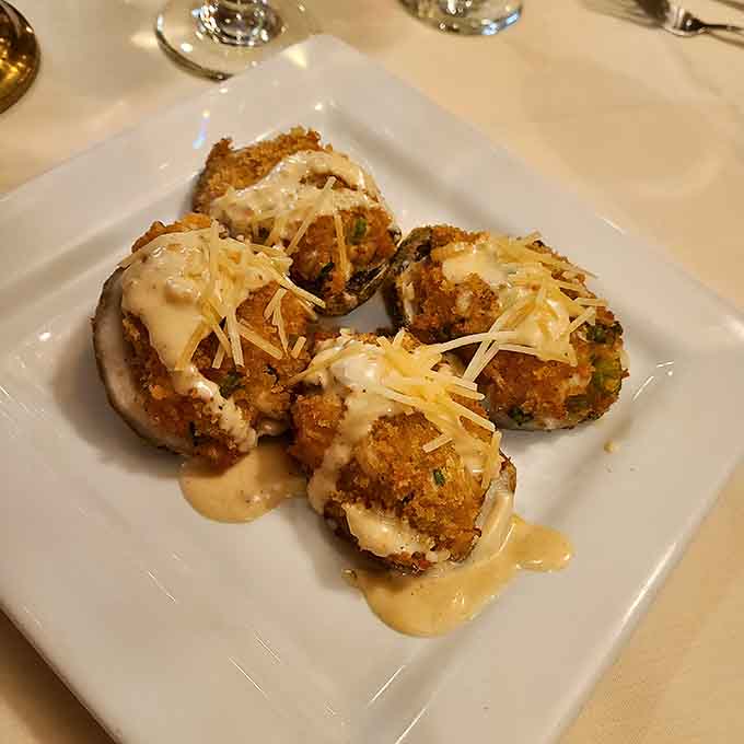 Breaded fried oysters draped in creamy sauce and shredded cheese, the kind of appetizer that makes ordering entrees harder.