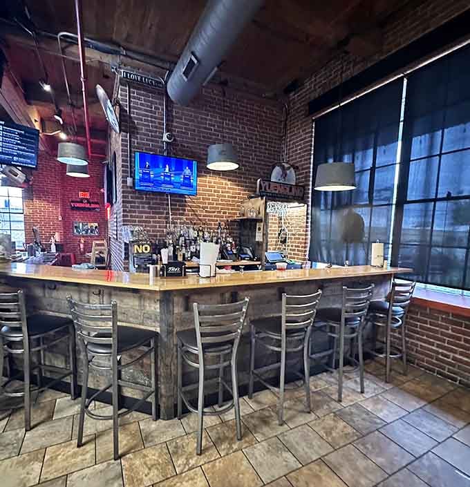 Exposed brick, Yuengling signage, and pendant lights hanging over a full bar. Philadelphia charm, no pretense required.
