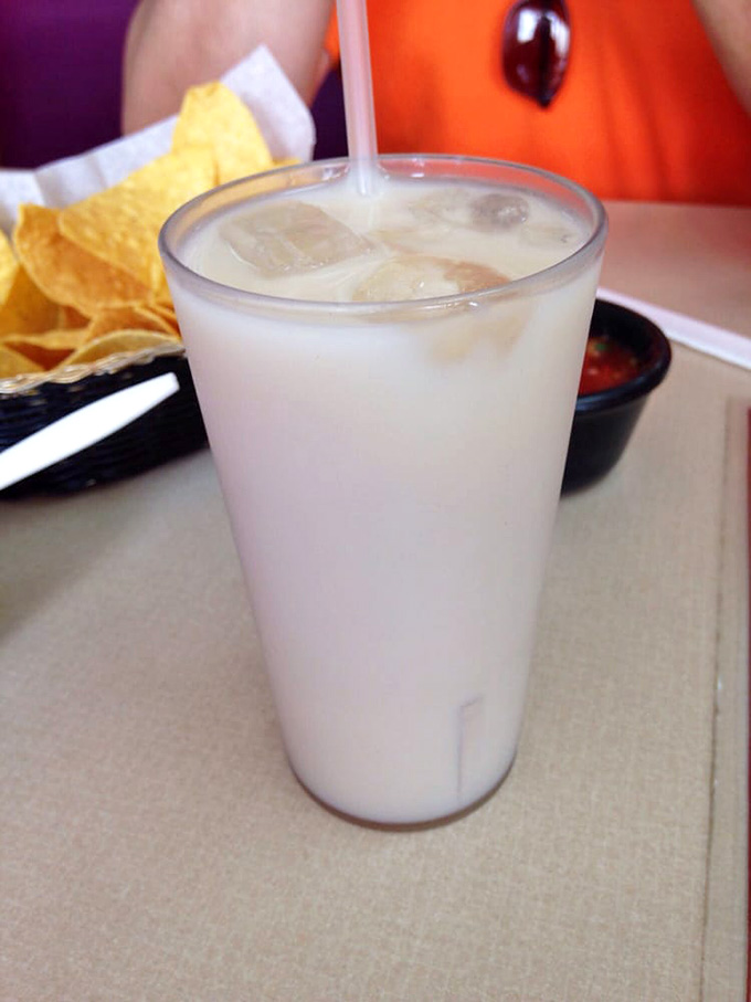Creamy, cold horchata sitting next to chips and salsa. The most refreshing sidekick a taco ever had.
