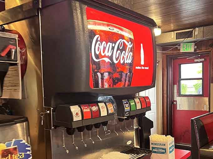 The Coca-Cola fountain machine standing guard like a classic American sentinel, ready to complete your meal perfectly.