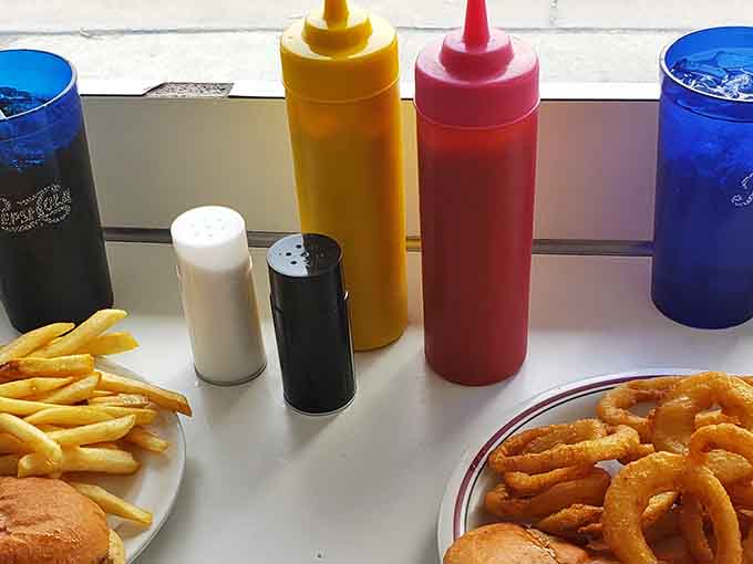 Ketchup, mustard, salt, pepper, blue glasses. The Telway table setup is classic diner perfection, no upgrades needed.