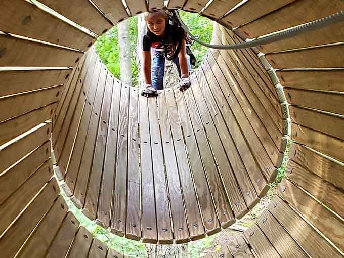 Crawling through a wooden tunnel high above the ground. Nobody said growing up was required here.