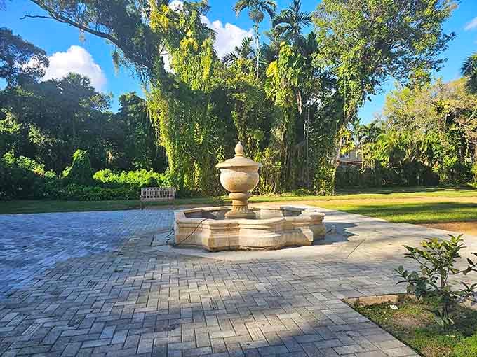 A stone fountain anchored by towering trees reminds you that some things are simply built to last forever.