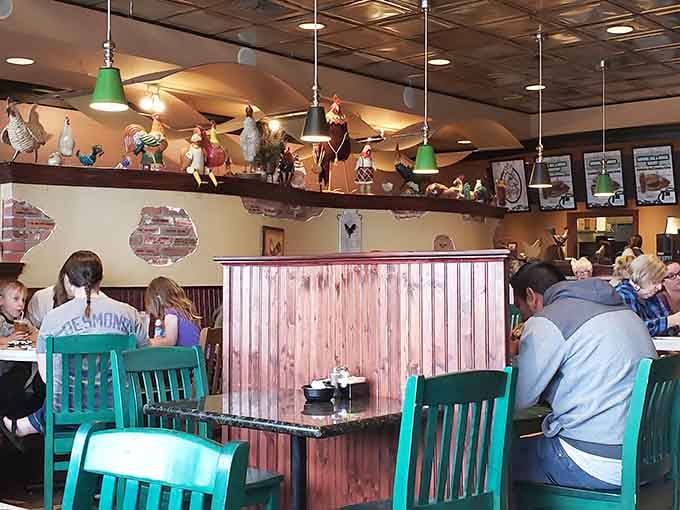 Families filling every teal chair, conversations flowing, plates arriving. This is what a beloved neighborhood spot looks like.