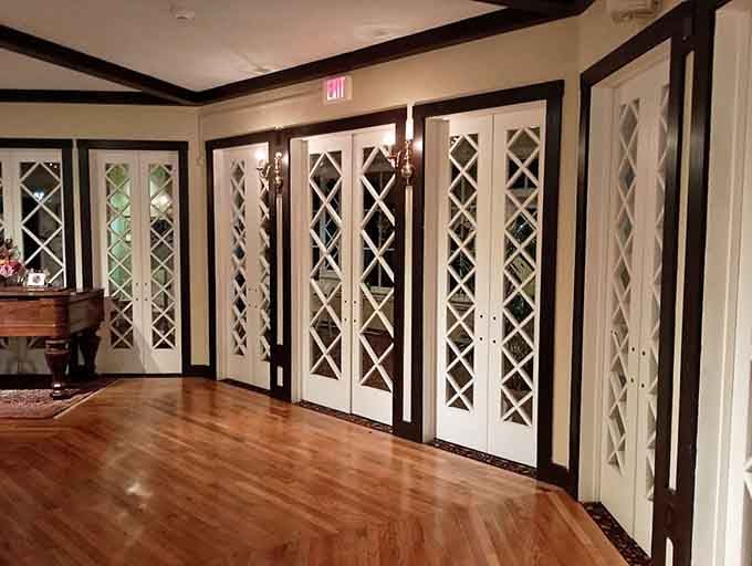 A row of diamond-paned French doors that make every exit feel like a dramatic and well-deserved departure.