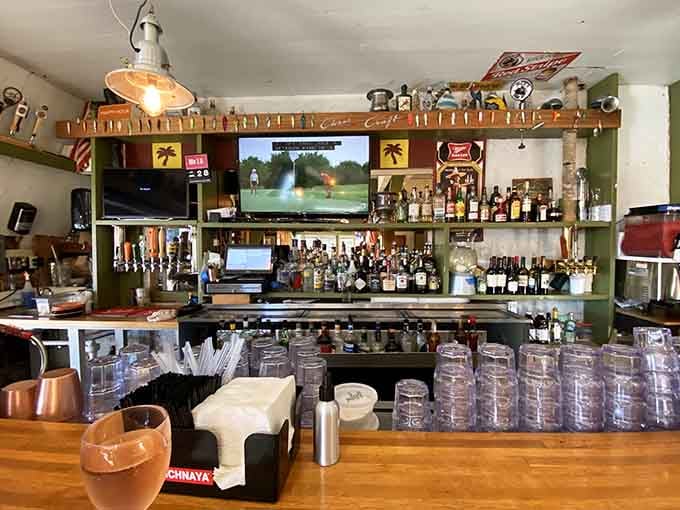 The bar lined with glassware and local charm serves drinks with a side of authentic fishing village vibes.