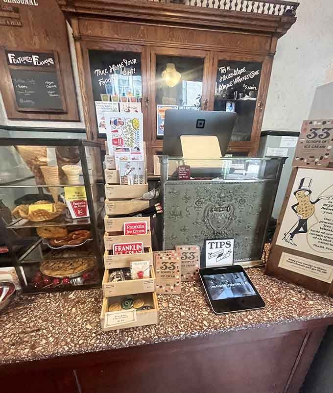 An antique cash register, stacked merchandise, and house-made waffle cones on display, this counter tells you everything about how seriously they take their craft.
