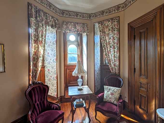 Two velvet chairs, a bay window, and afternoon light filtering through the glass. This little sitting nook is pure Victorian charm.