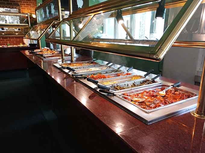 A long buffet line glowing under warm lights, tray after tray of Southern dishes waiting patiently, this is the promised land.