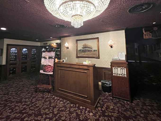 The host station welcomes you with a chandelier overhead, setting expectations high before you've even seen the menu options.