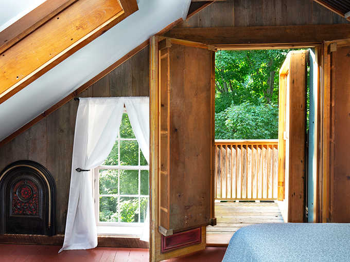 A skylight, a private balcony, and wood walls that smell like a very good decision.