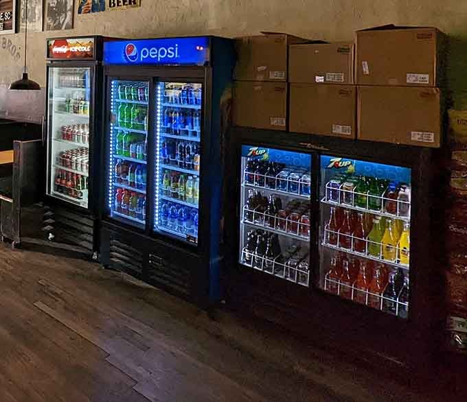 Refrigerators stocked with cold drinks glow like beacons of refreshment after your chili dog adventure.