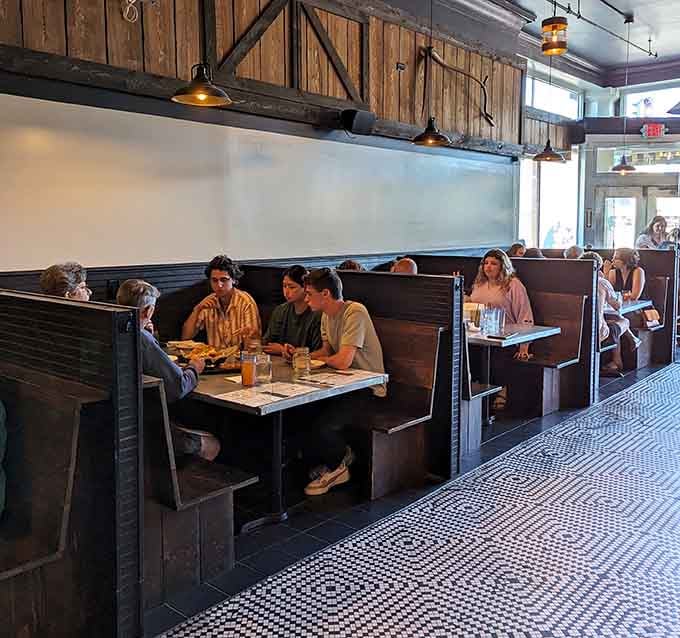 A full house of happy diners in dark wood booths. This is what a neighborhood restaurant is supposed to feel like.
