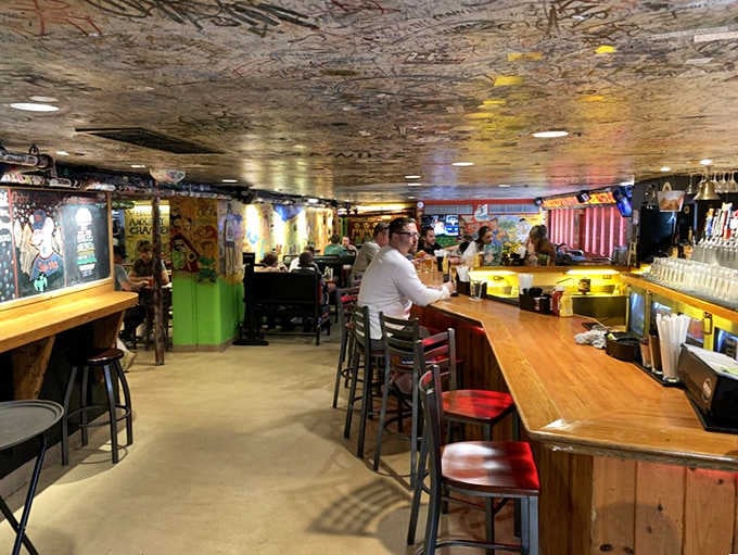 A long wooden bar lined with tap handles. The Sink takes its drinks just as seriously as its burgers.