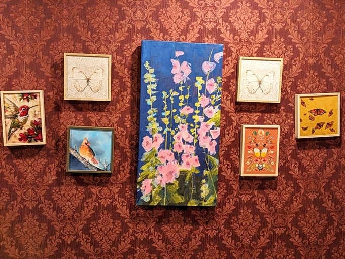 Butterfly art and bird paintings on damask wallpaper, because every wall deserves its own story.