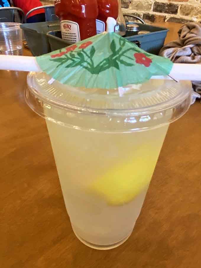 Fresh lemonade with a cheerful umbrella garnish, because even drinks deserve to have a little fun sometimes.