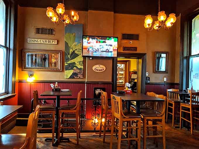 Vintage signs, warm chandeliers, and a Chimay poster that quietly tells you this bar has excellent taste.