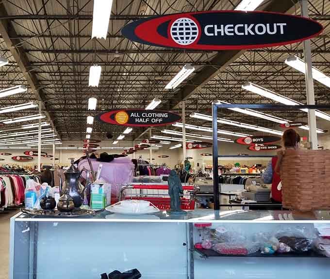 The checkout sign overhead says it all, and that "All Clothing Half Off" banner seals the deal completely.