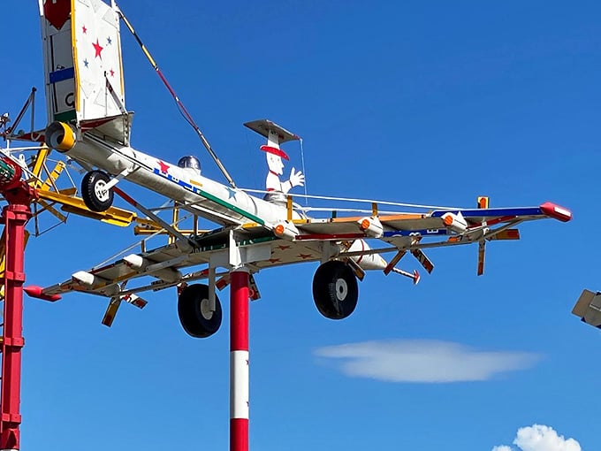 That's a pilot up there, riding a wind-powered plane made from scrap, and somehow it all makes perfect sense.