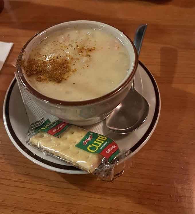 A steaming bowl of clam chowder with crackers on the side, warm, creamy, and the perfect way to start things off right.