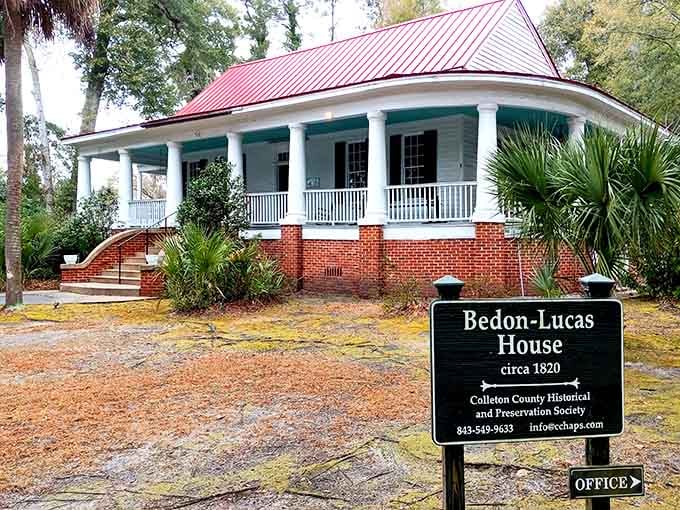 A wraparound porch, red metal roof, and a sign reading "circa 1820" that puts your own age in refreshing perspective.