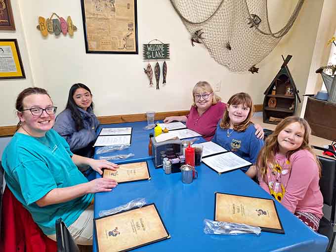 Happy faces around a blue-tablecloth table, menus open, smiles ready. Walt's has a way of doing that to people.