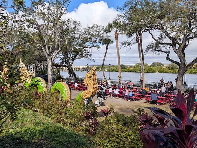 Naga serpent sculptures weave through lush greenery while red picnic tables fill with very lucky Sunday diners.