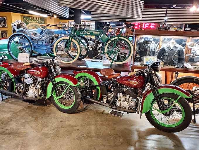 Red fenders, green trim, and a Marsh bicycle in the background, this corner of the museum is a full century of American wheels in one glance.