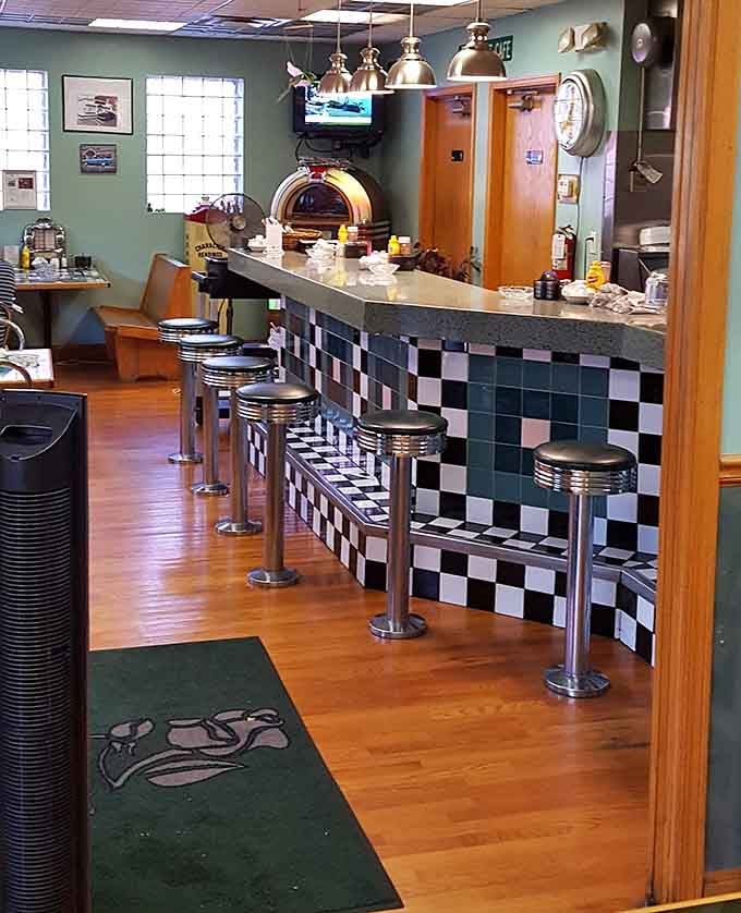 A black and white checkered counter, chrome stools, and a jukebox waiting in the corner, this is the real deal.