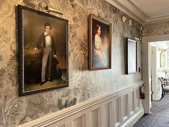 Portrait-lined hallways with dramatic floral wallpaper. Walking these corridors feels like strolling through a living history painting.