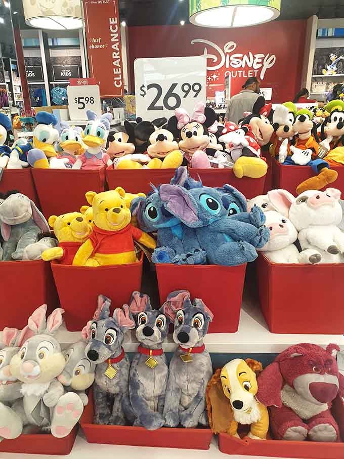 Disney plush toys piled high in bright red bins, guaranteed to make every kid in a five-mile radius unreasonably happy.