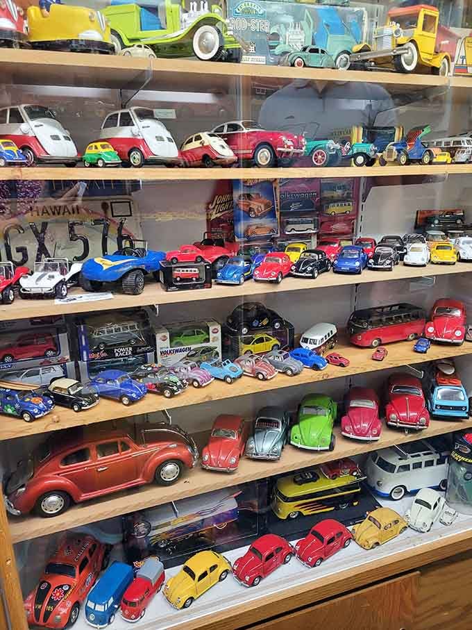 Shelf after shelf of die-cast Volkswagens at the World's Largest Toy Museum Complex, because apparently someone loved Beetles very, very much.