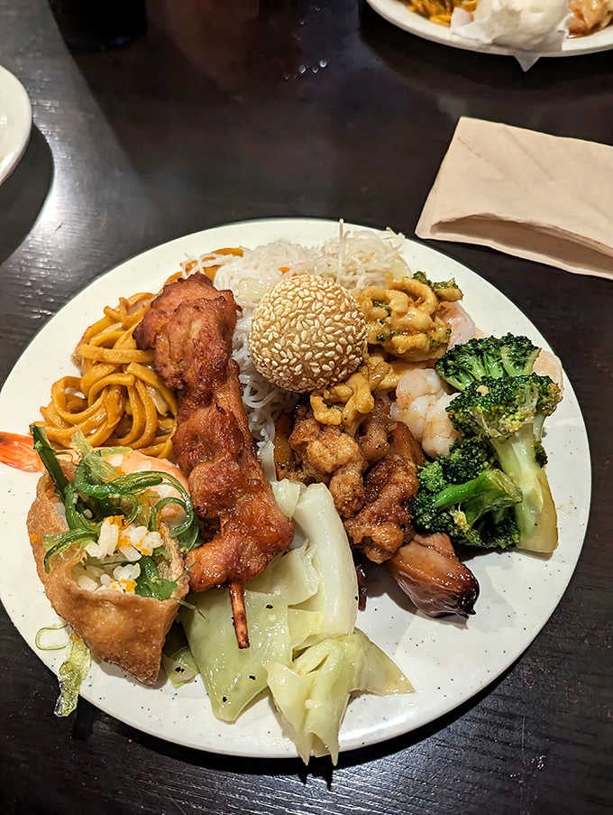 Sesame balls, noodles, fried chicken skewers, shrimp, and broccoli. One plate, endless personality, zero complaints whatsoever.