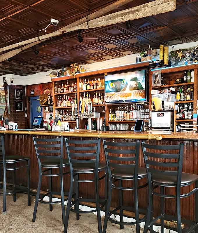 The bar area where locals gather, stories flow freely, and the TV plays whatever game matters most that day.
