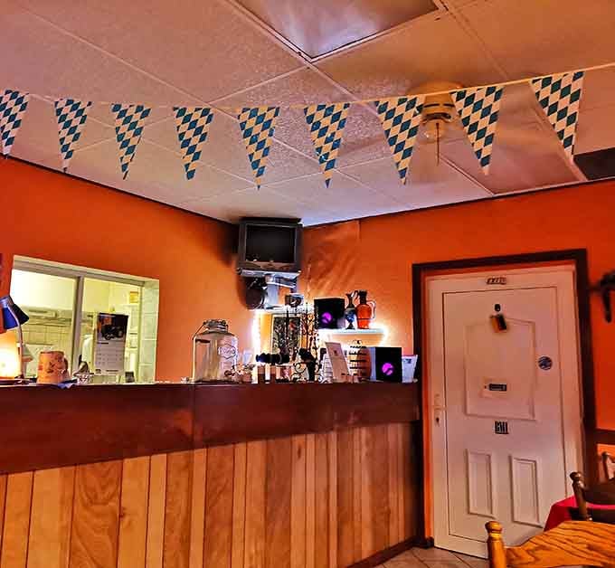 The cozy service counter anchors the room, Bavarian pennants above and warm light glowing, everything here feels personal and intentional.