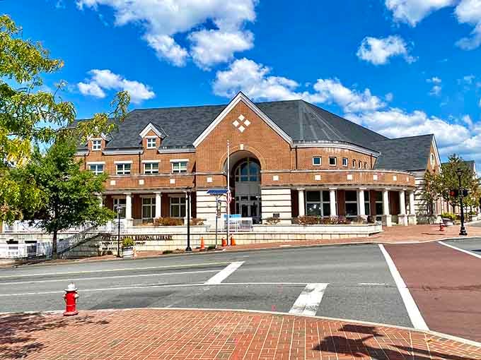 Admire the grand brick architecture of this local library building, featuring striking arches and neat white columns out front.