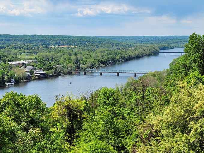 The Delaware River winds below like a silver ribbon, connecting Pennsylvania and Jersey in peaceful harmony.