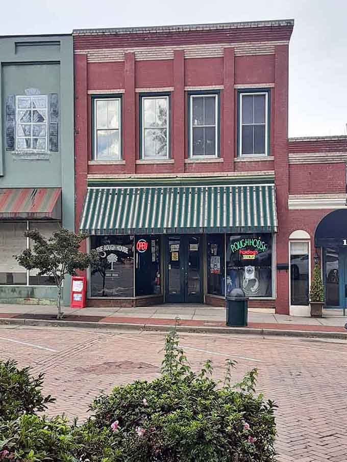 That handsome red brick facade and green-striped awning on Abbeville's Court Square make The Rough House look like history you can eat.