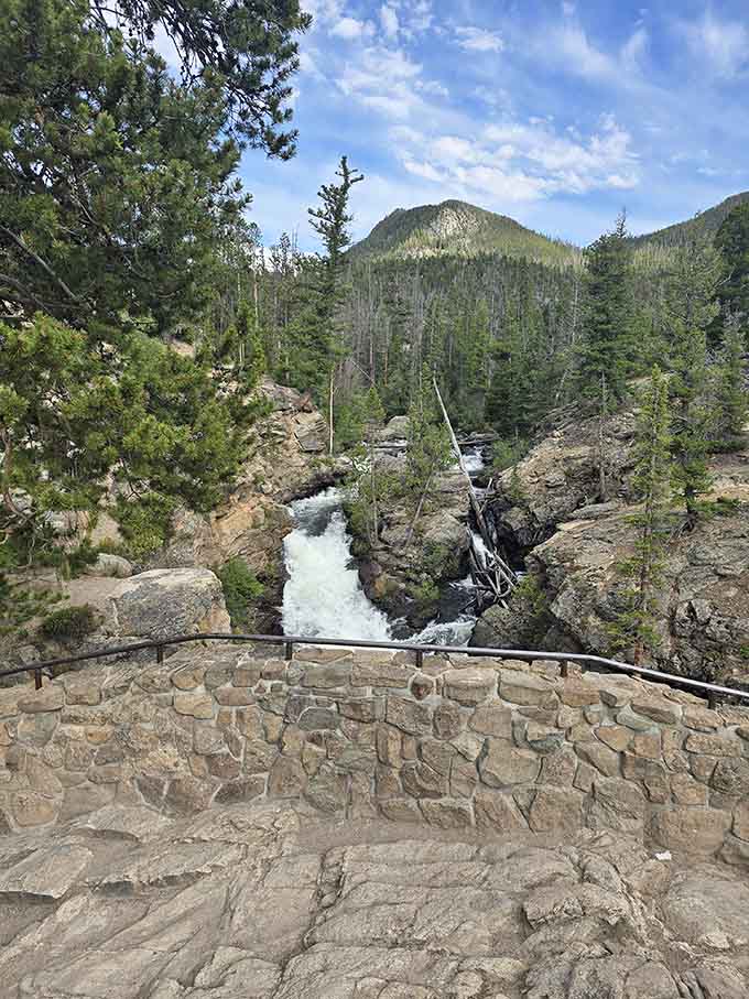 A stone overlook wall frames the rushing water below Adams Falls, giving you a front-row seat to one of the park's most energetic performances.