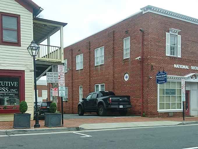 Stroll down a historic brick sidewalk past classic storefronts and a parked truck tucked into a neat downtown alleyway.