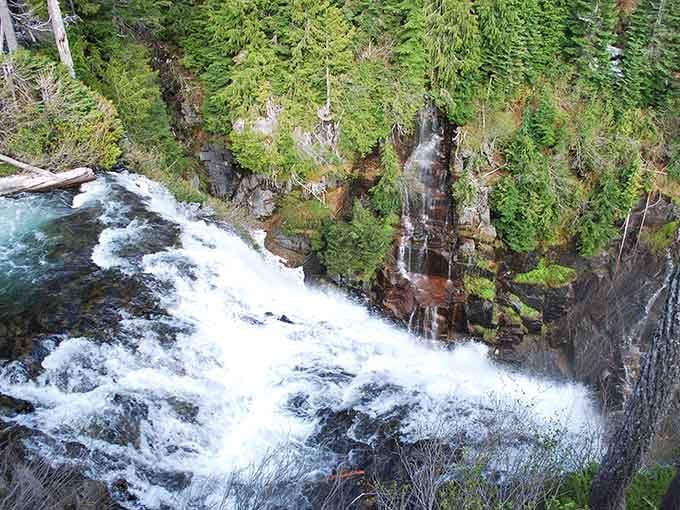 White water crashes over moss-covered rocks while mist rises like applause for this spectacular natural performance.