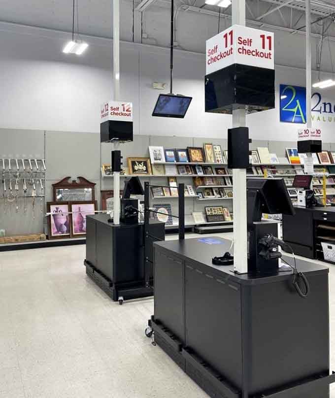 Self-checkout stations standing ready under bright lights, with framed art and more treasures visible in the background, the finish line never looked this good.