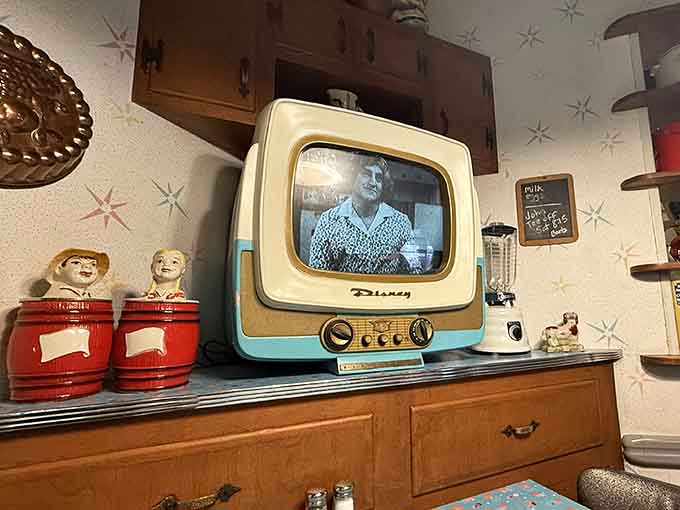 A turquoise Disney television set playing black and white classics. This is the only screen time worth having at dinner.