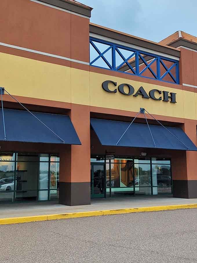 The Coach store beckons with leather goods that whisper luxury while the price tags practically shout "what a deal!"