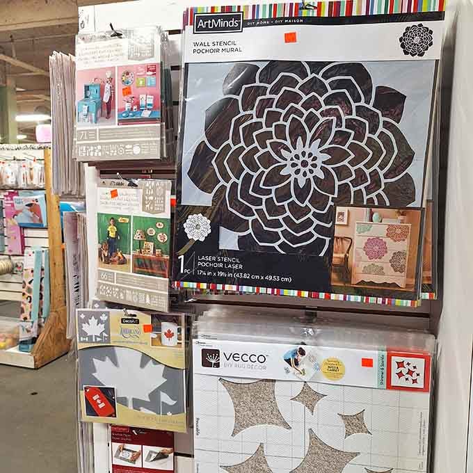 Wall stencils and DIY art supplies tucked among the fabric, because All About Fabrics believes creativity has no single lane.