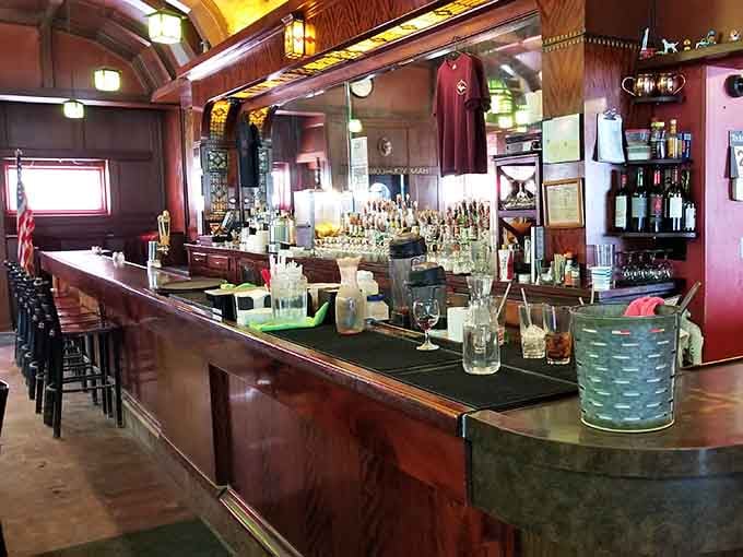 The bar stretches invitingly beneath vintage fixtures, ready to serve something sophisticated or just whatever's cold.