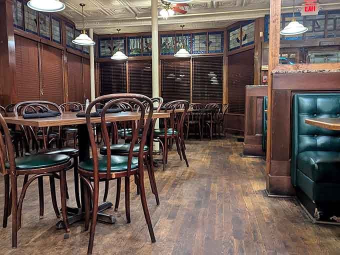 Bentwood chairs, hardwood floors, and stained glass above. Amber Rose's dining room is a warm hug you can sit inside.