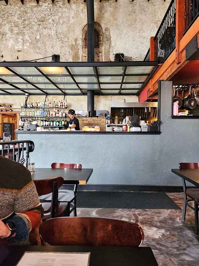 An open kitchen with a full bar behind it, where the real magic happens one stone hearth-baked dish at a time.